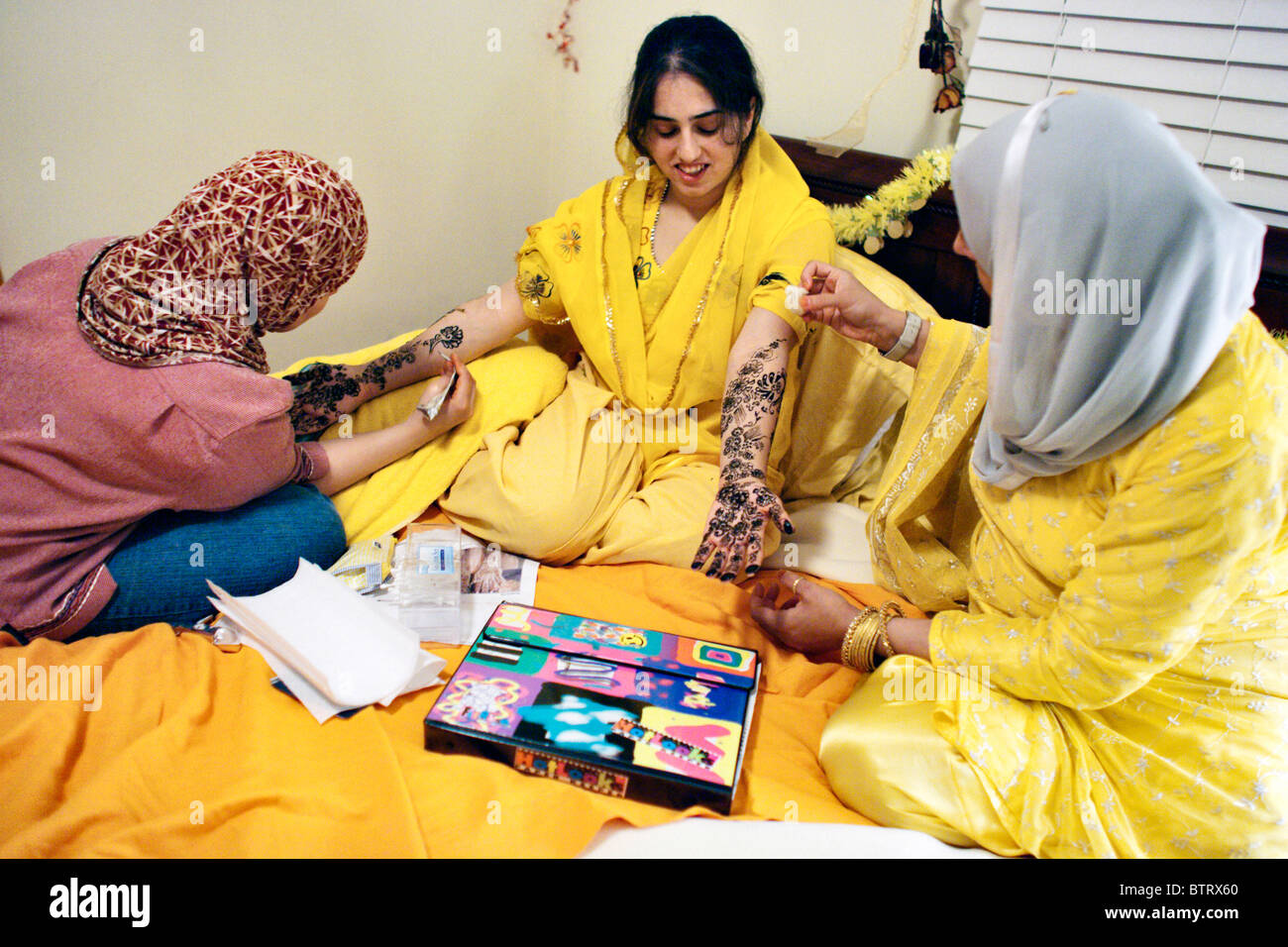 Young Muslim bride-to-be has elaborate henna designs painted on her ...