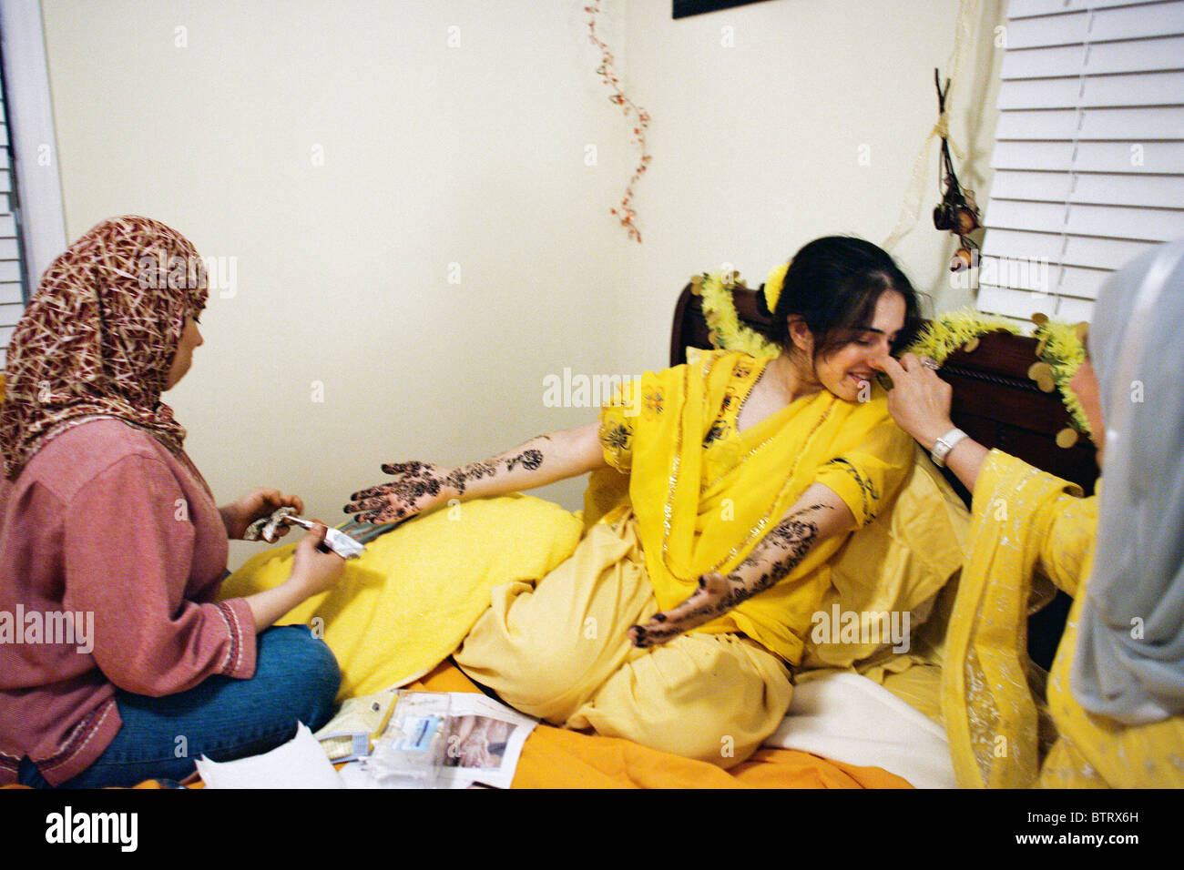 Young Muslim bride-to-be has elaborate henna designs painted on her ...