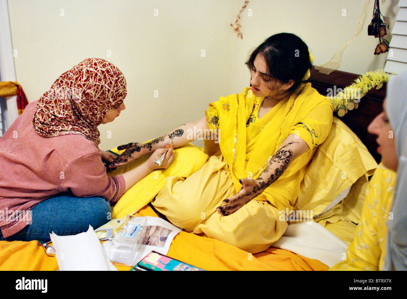 Young Muslim bride-to-be has elaborate henna designs painted on her ...