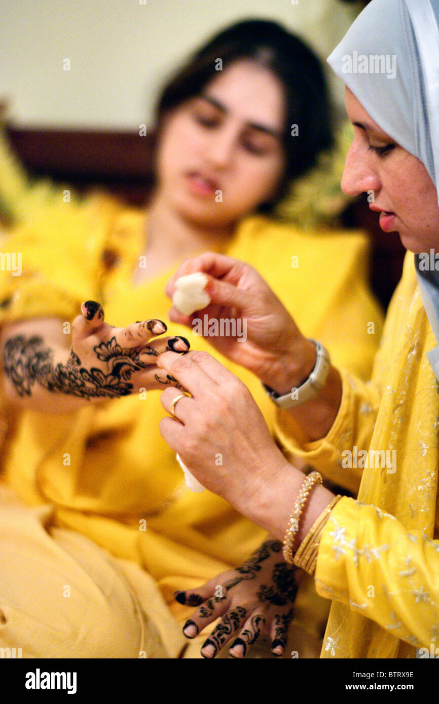 Young Muslim bride-to-be has elaborate henna designs painted on her ...