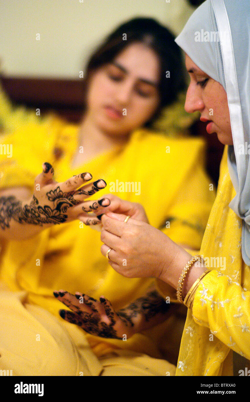 Young Muslim bride-to-be has elaborate henna designs painted on her ...