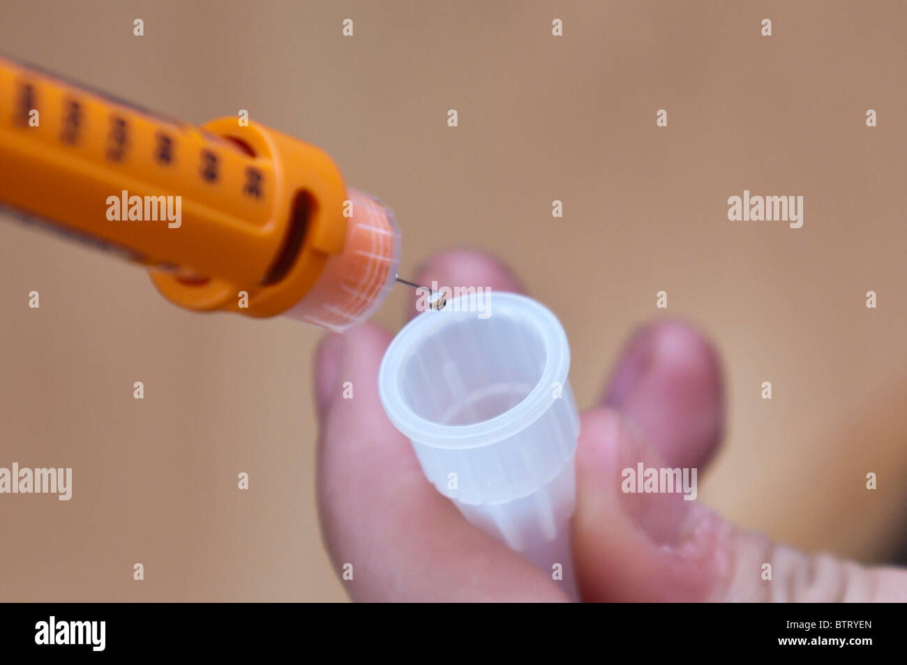 Young diabetic girl prepares an injection of insulin to treat diabetes ...