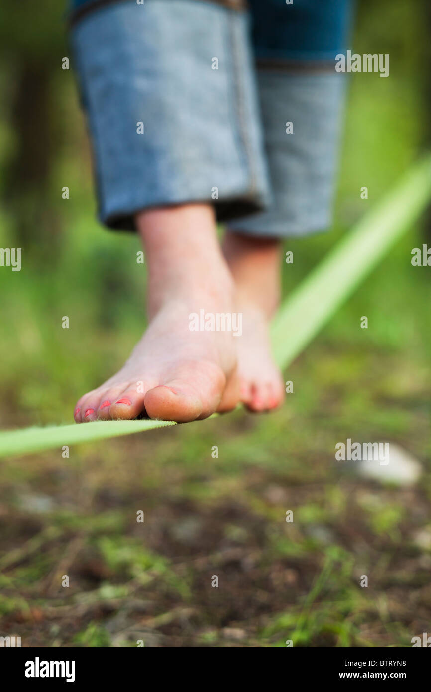 Closeup view of a womans feet on a slack line Stock Photo - Alamy
