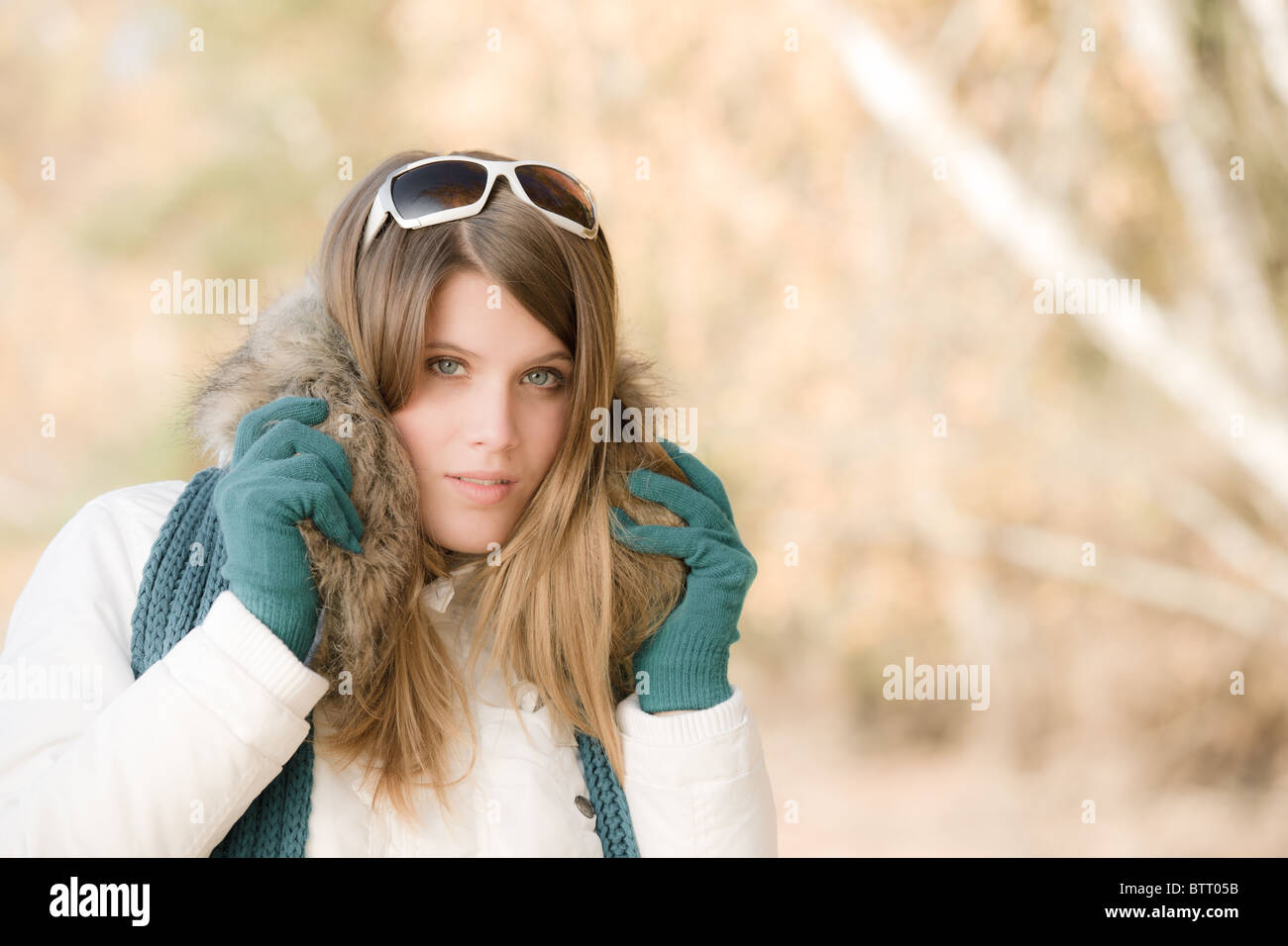 Winter fashion - woman with fur hood and gloves outside, desaturated ...