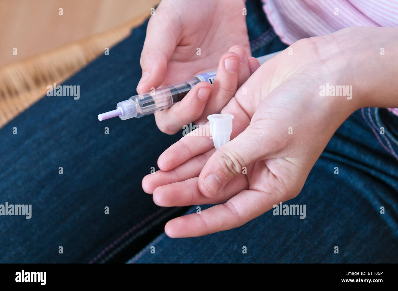 Young diabetic girl prepares an injection of insulin to treat diabetes ...