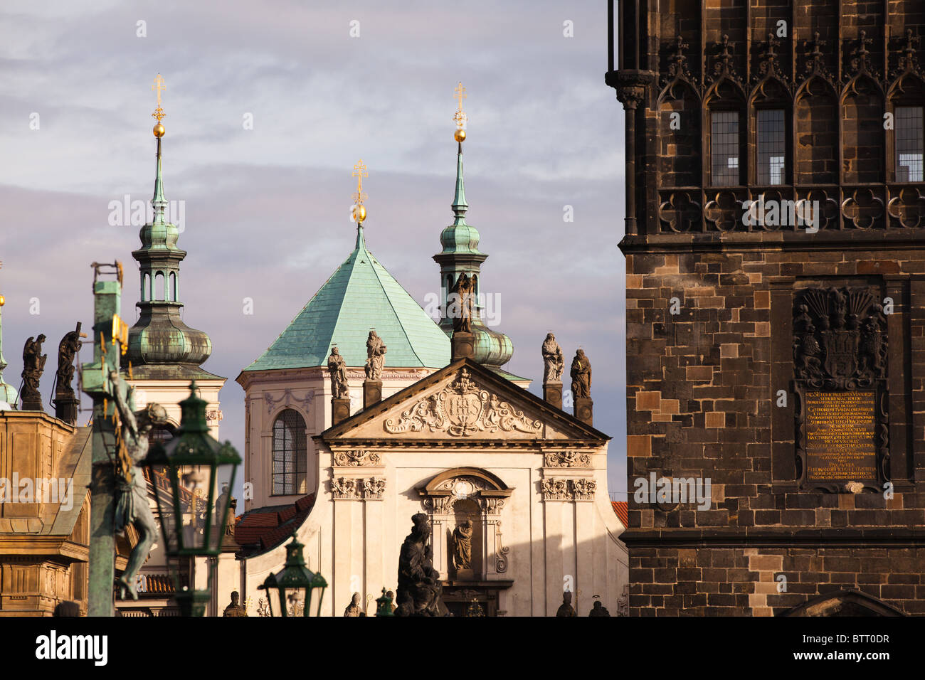 Prague cross on the Charles Bridge by sunset Stock Photo - Alamy