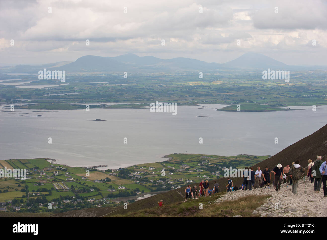 People climbing Croagh Patrick a holy mountain in County Mayo, Ireland ...