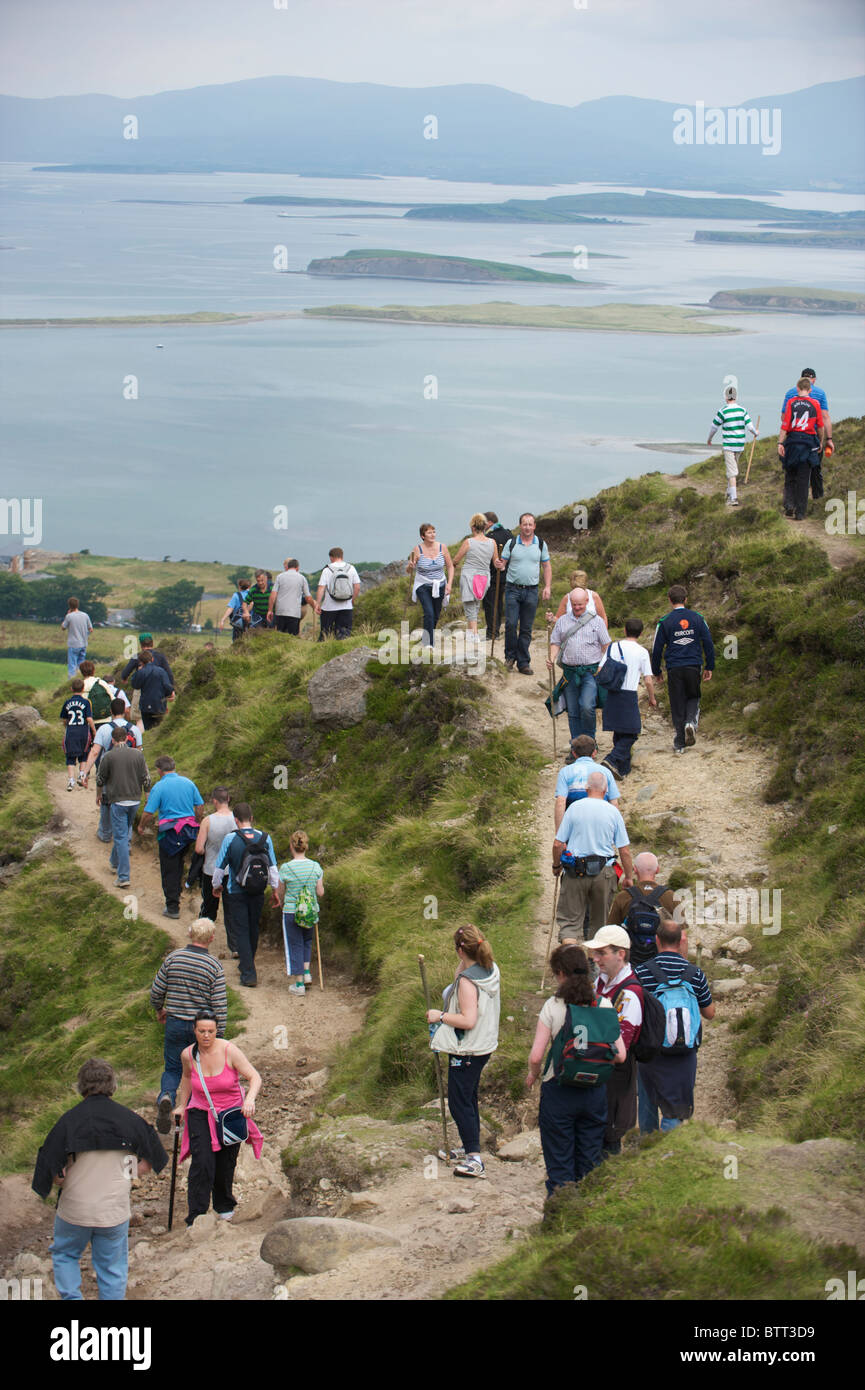 People climbing Croagh Patrick a holy mountain in County Mayo, Ireland ...