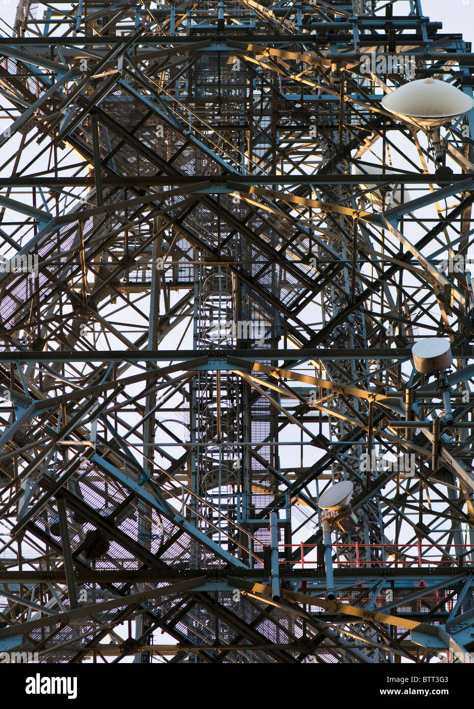 Detail of a complex communication tower with steel struts and microwave ...