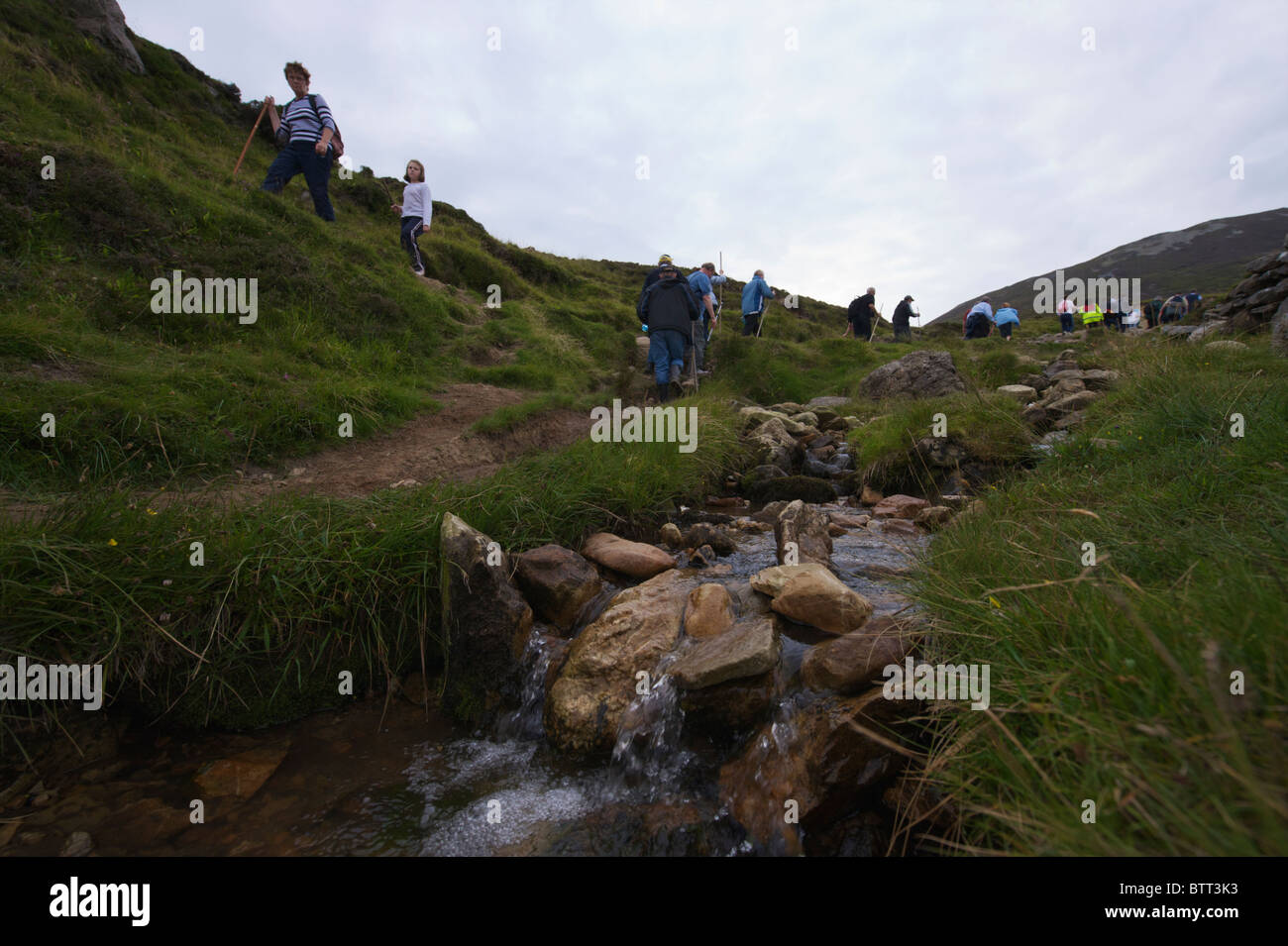 People climbing Croagh Patrick a holy mountain in County Mayo, Ireland ...