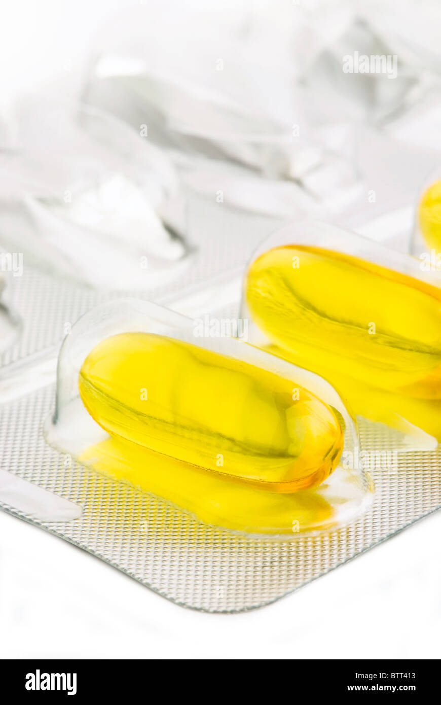 Macro of transparent pills of vitamin in half empty blister. Sallow ...