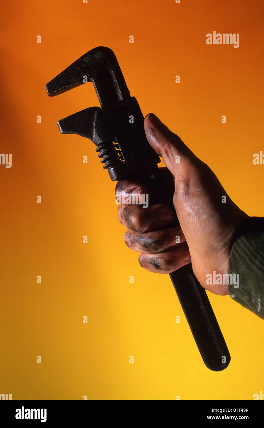 mechanic with oily hand holding adjustable spanner Stock Photo - Alamy