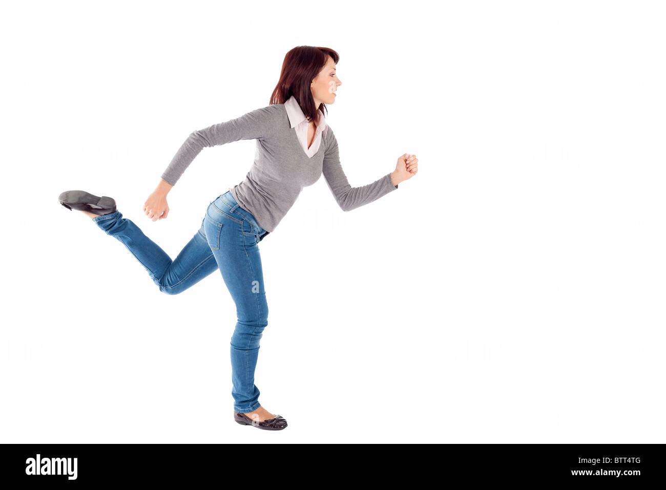 Casual young woman in running pose, isolated on white background Stock ...