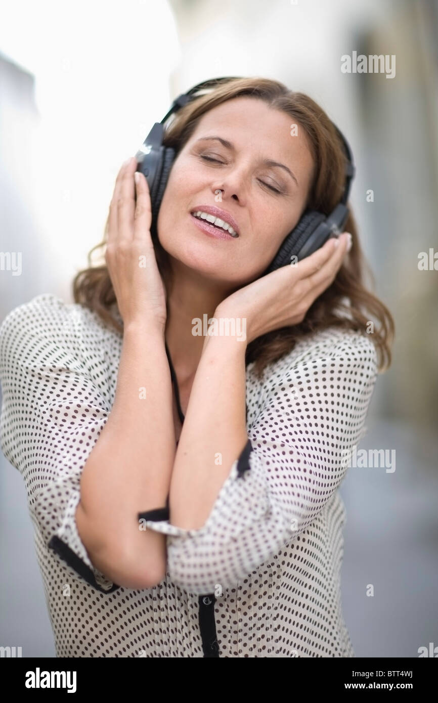 Woman hearing music Stock Photo - Alamy