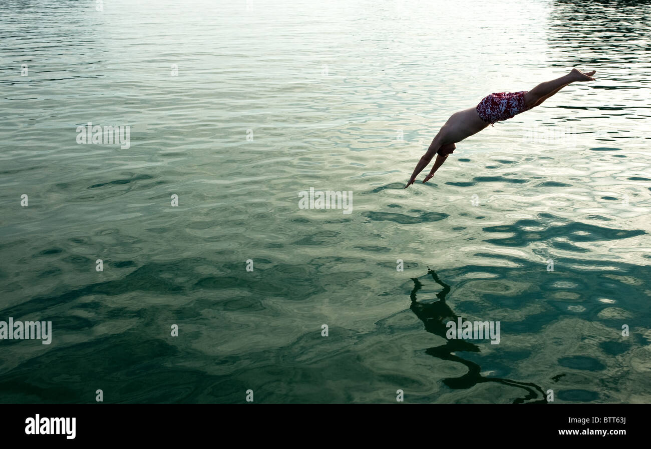 The silhouette of a man diving into water Stock Photo - Alamy