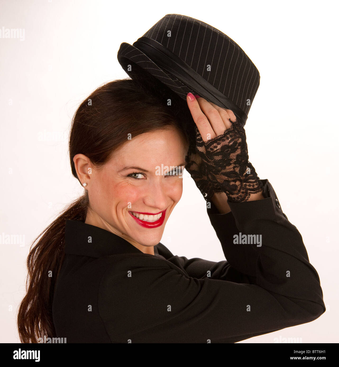 Beautiful Brunette Woman plays with stylish hat Stock Photo - Alamy