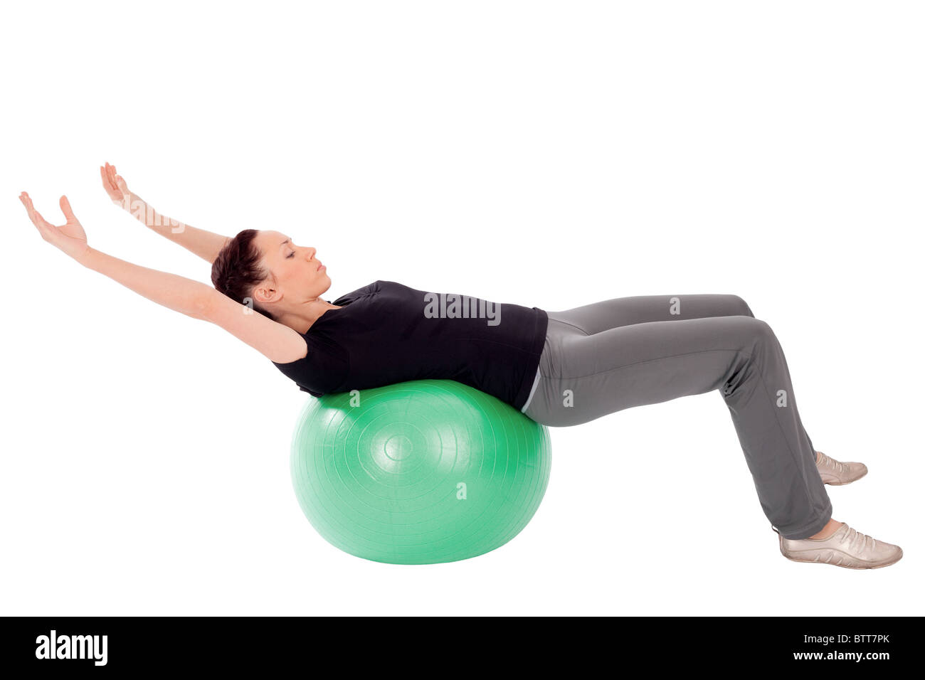 Fit woman doing abdominal stretch exercise with gym ball, isolated on ...
