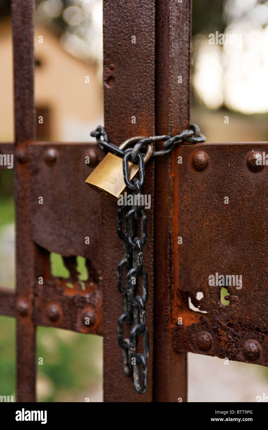 Old rusty gate locked with chain and new lock, close up, Italy, Tuscany ...