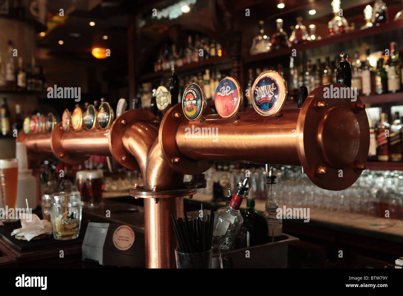 Interior of an Irish style pub draught beer taps Stock Photo - Alamy