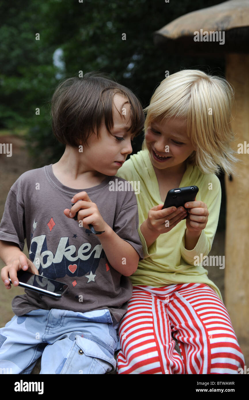 children using the apple iphone at kew gardens, london Stock Photo - Alamy
