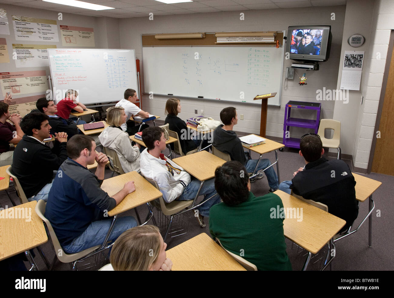 Male and female students watch Barack Obama's inauguration on TV during ...