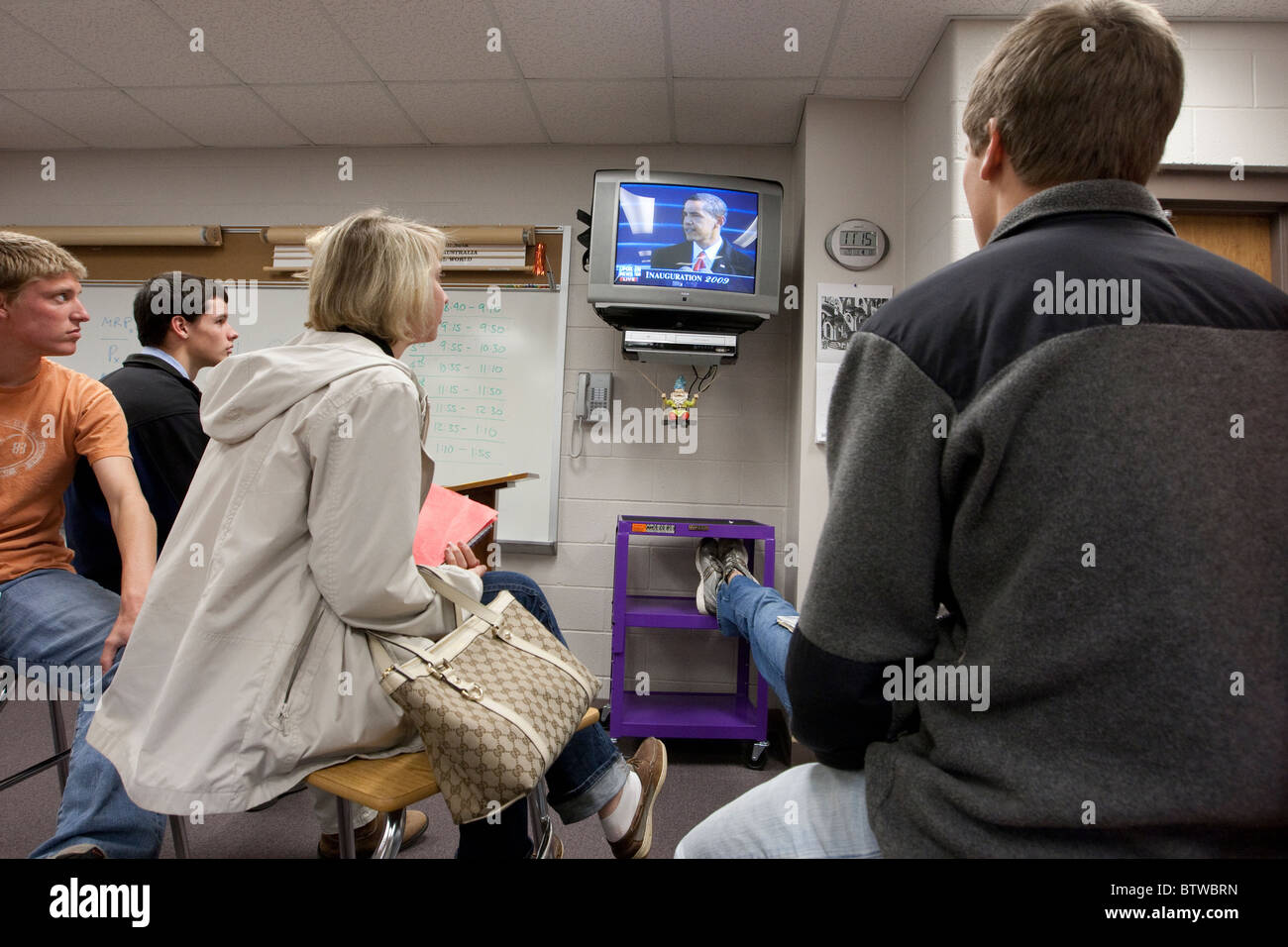 Male and female students watch Barack Obama's inauguration on TV during ...