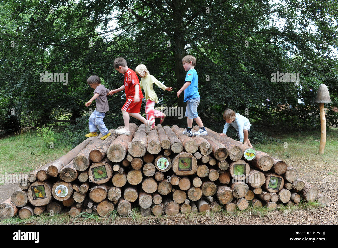 children playing on kew gardens log pile Stock Photo - Alamy