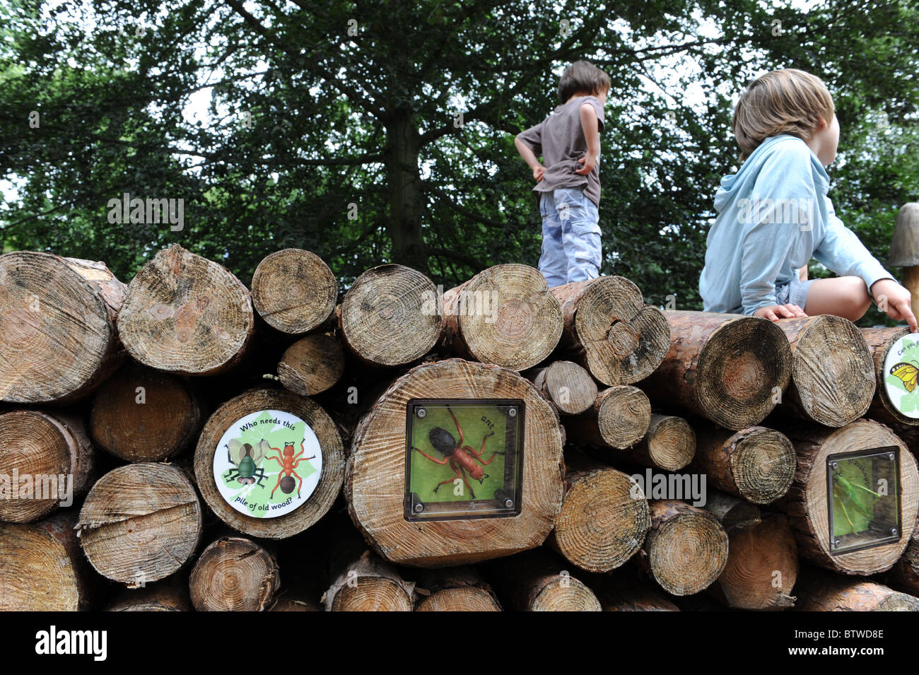 children playing on kew gardens log pile Stock Photo - Alamy