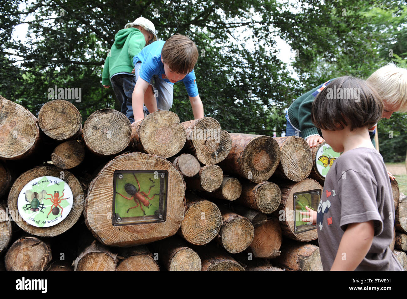 children playing on kew gardens log pile Stock Photo - Alamy