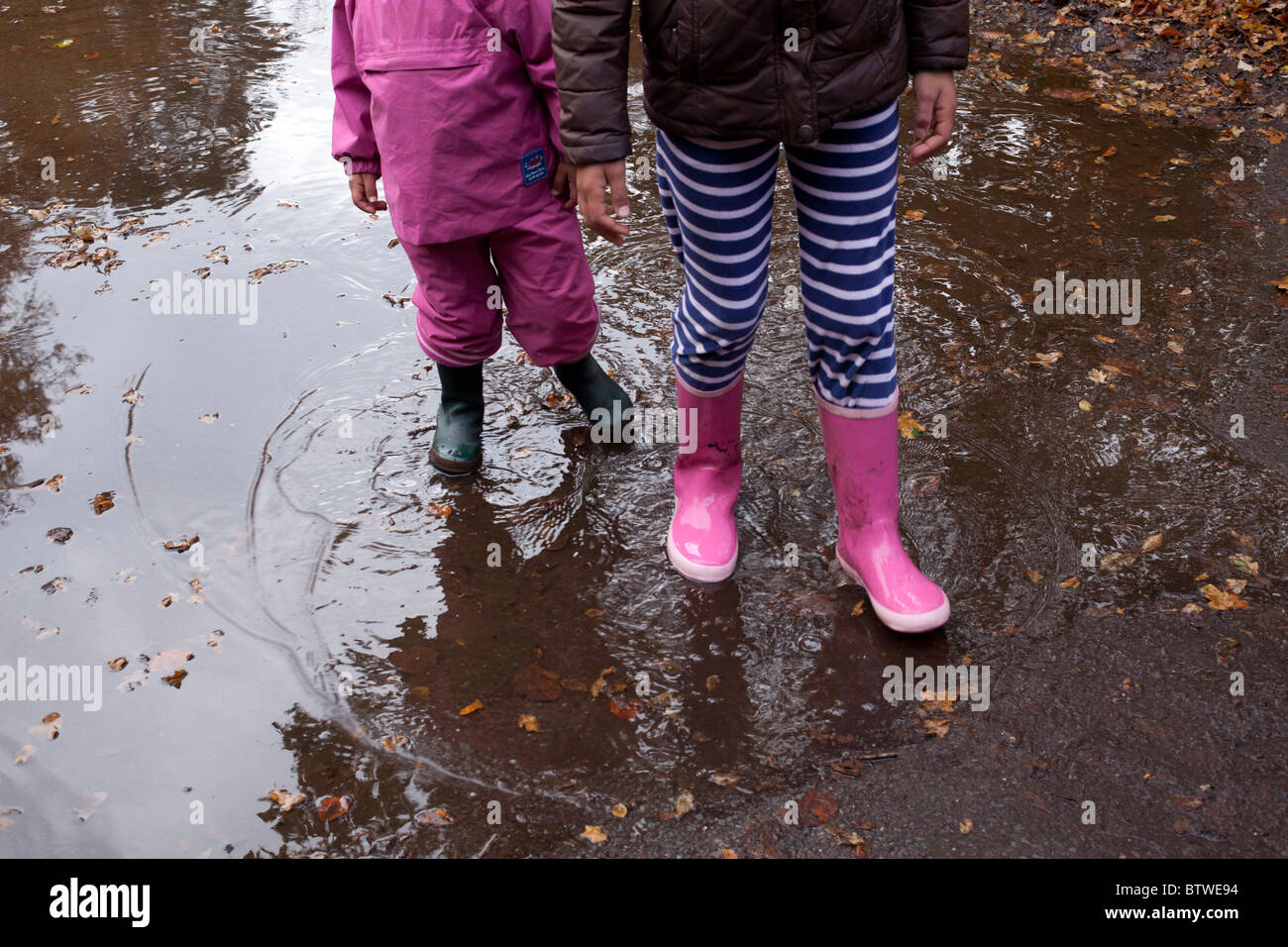 Kids playing in puddle Stock Photo - Alamy