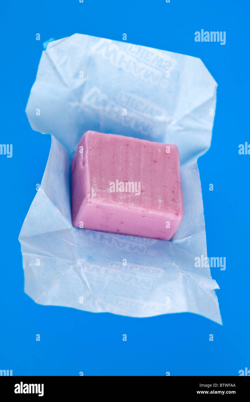 Pink sweet chew and wrapper Stock Photo - Alamy