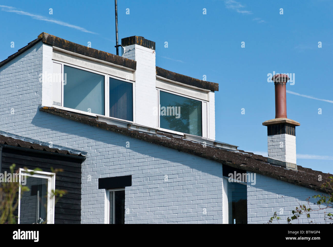 Angular roof-lines on bespoke house from 1970s in UK Stock Photo - Alamy