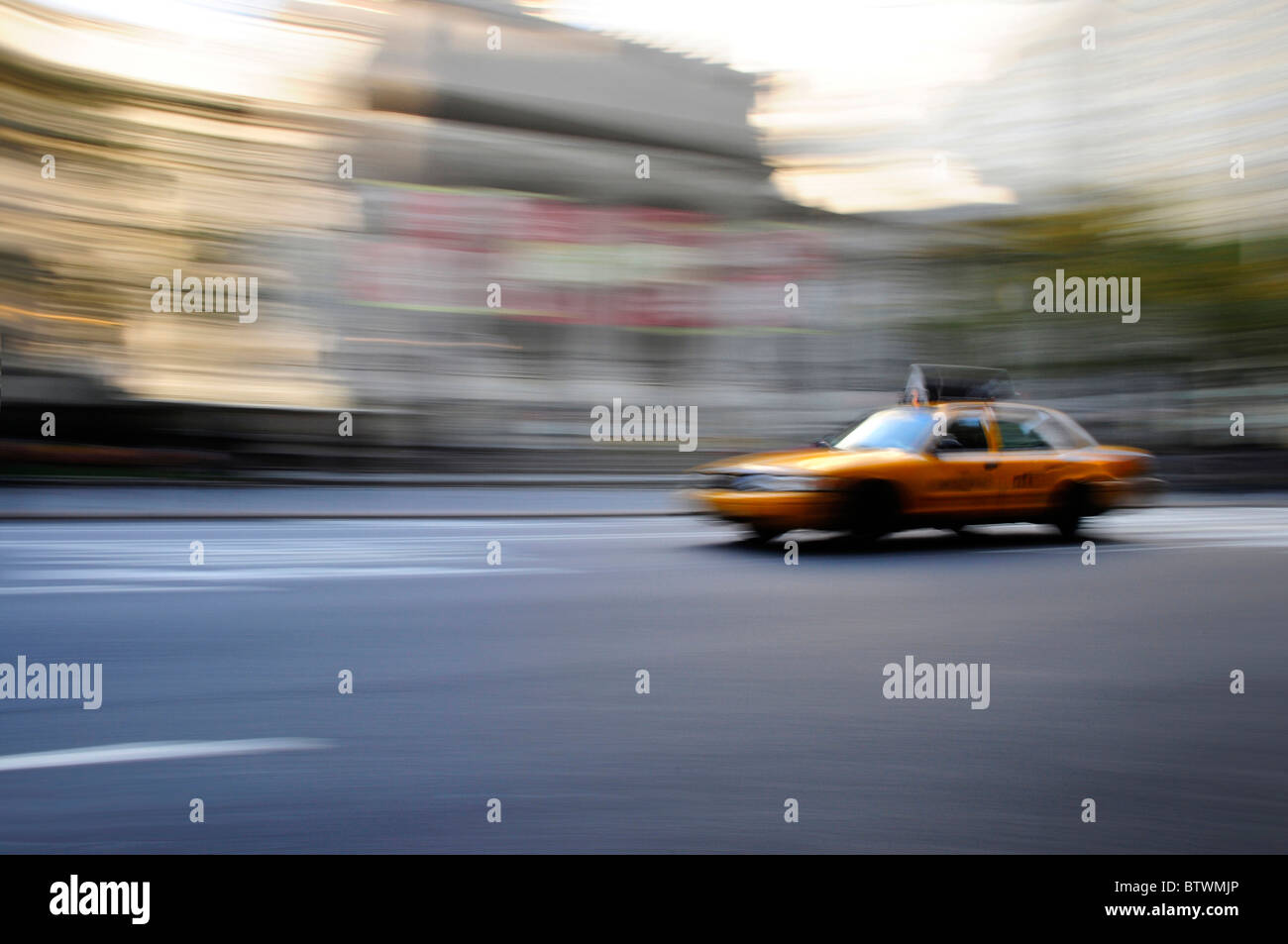 Taxi cab speeding down an urban street in a blur Stock Photo - Alamy
