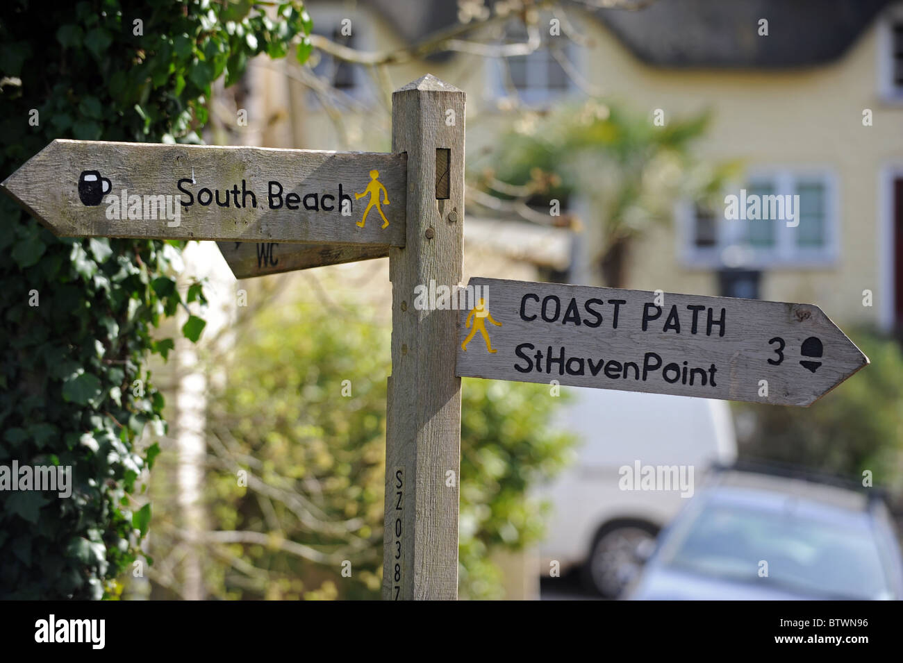 Wooden signpost to studland south beach and coast path Stock Photo - Alamy