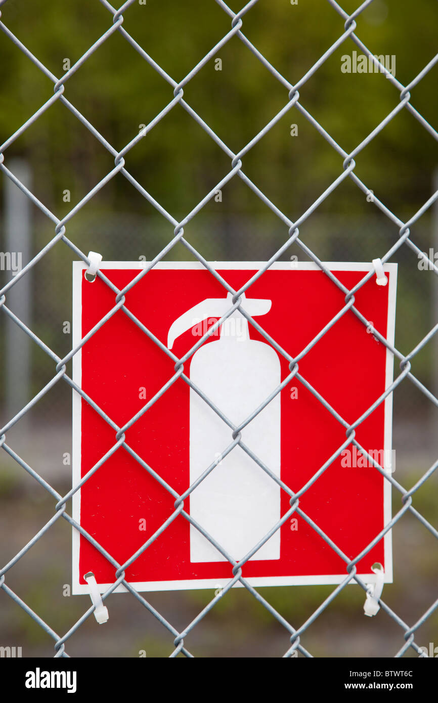 Fire extinguisher sign on wire-netting fence Stock Photo - Alamy