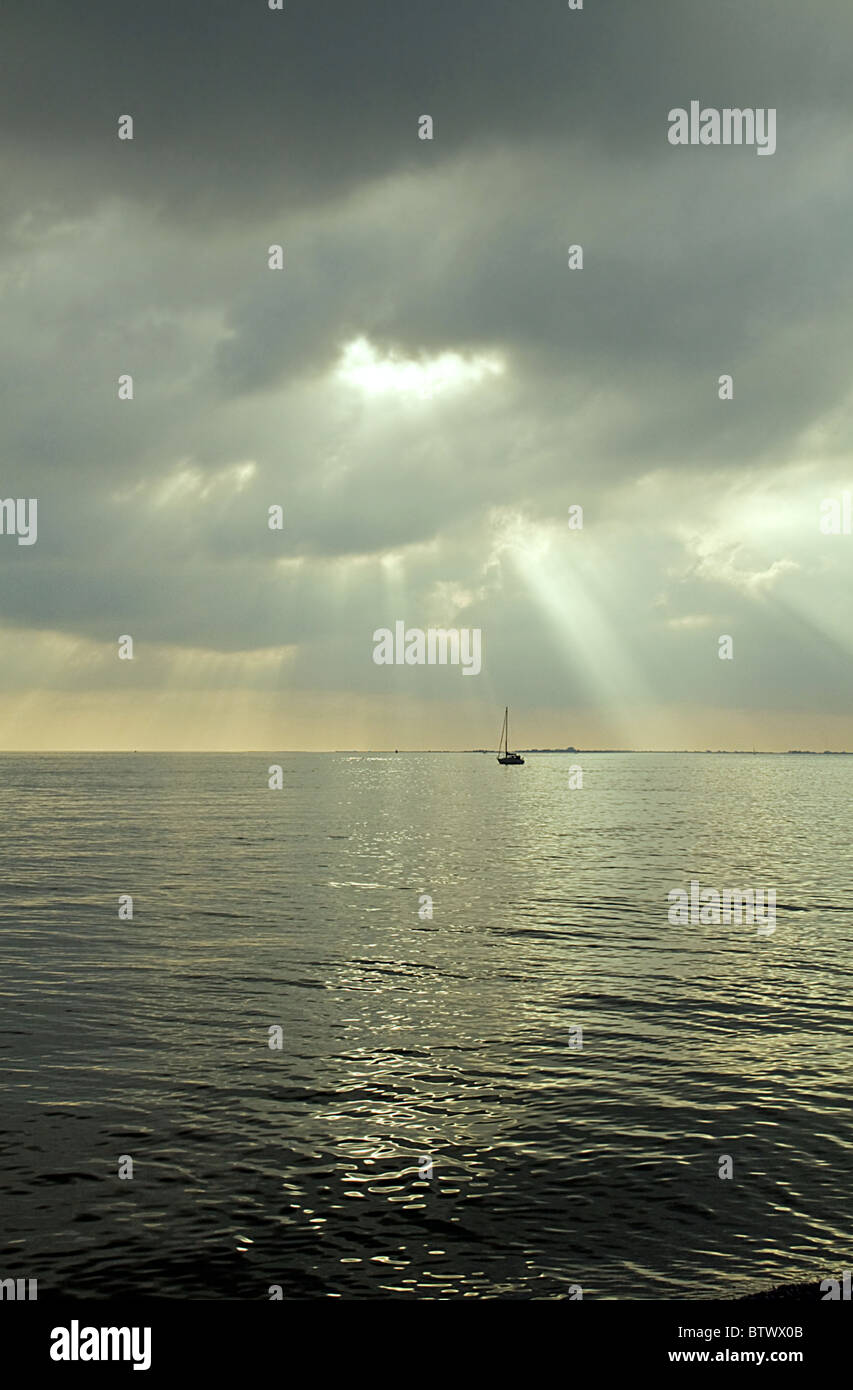 Winter sun rays on sea with silver reflections Stock Photo - Alamy