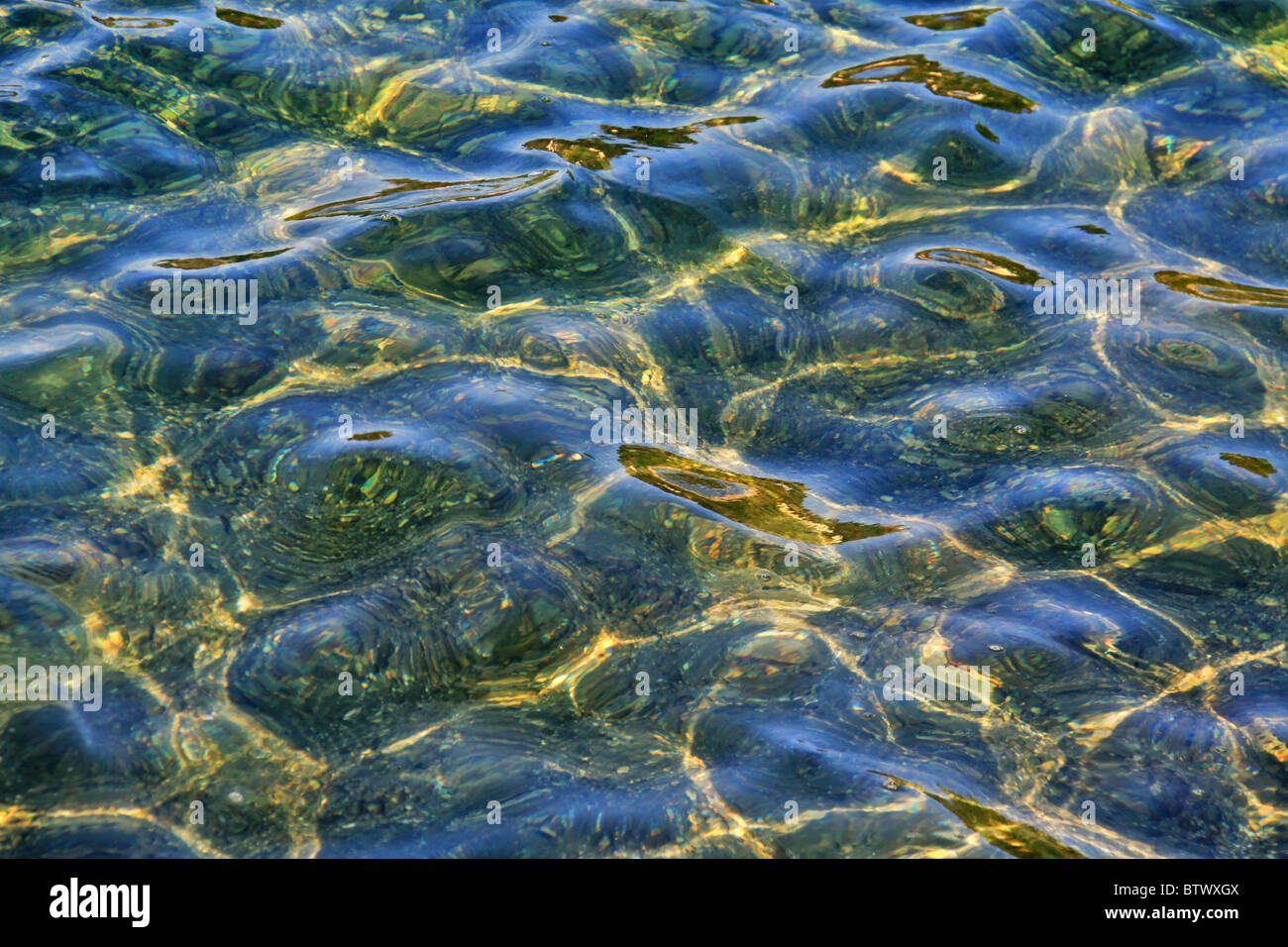 Light reflection of golden beams through crystal clear sea water Stock ...