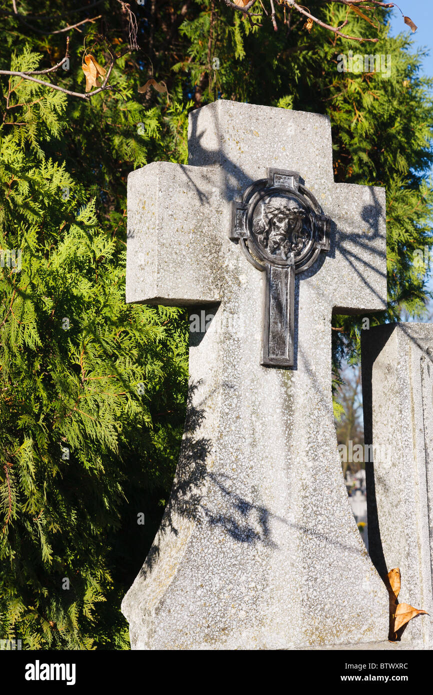 Stone cross with metal figurine of jesus christ Stock Photo - Alamy