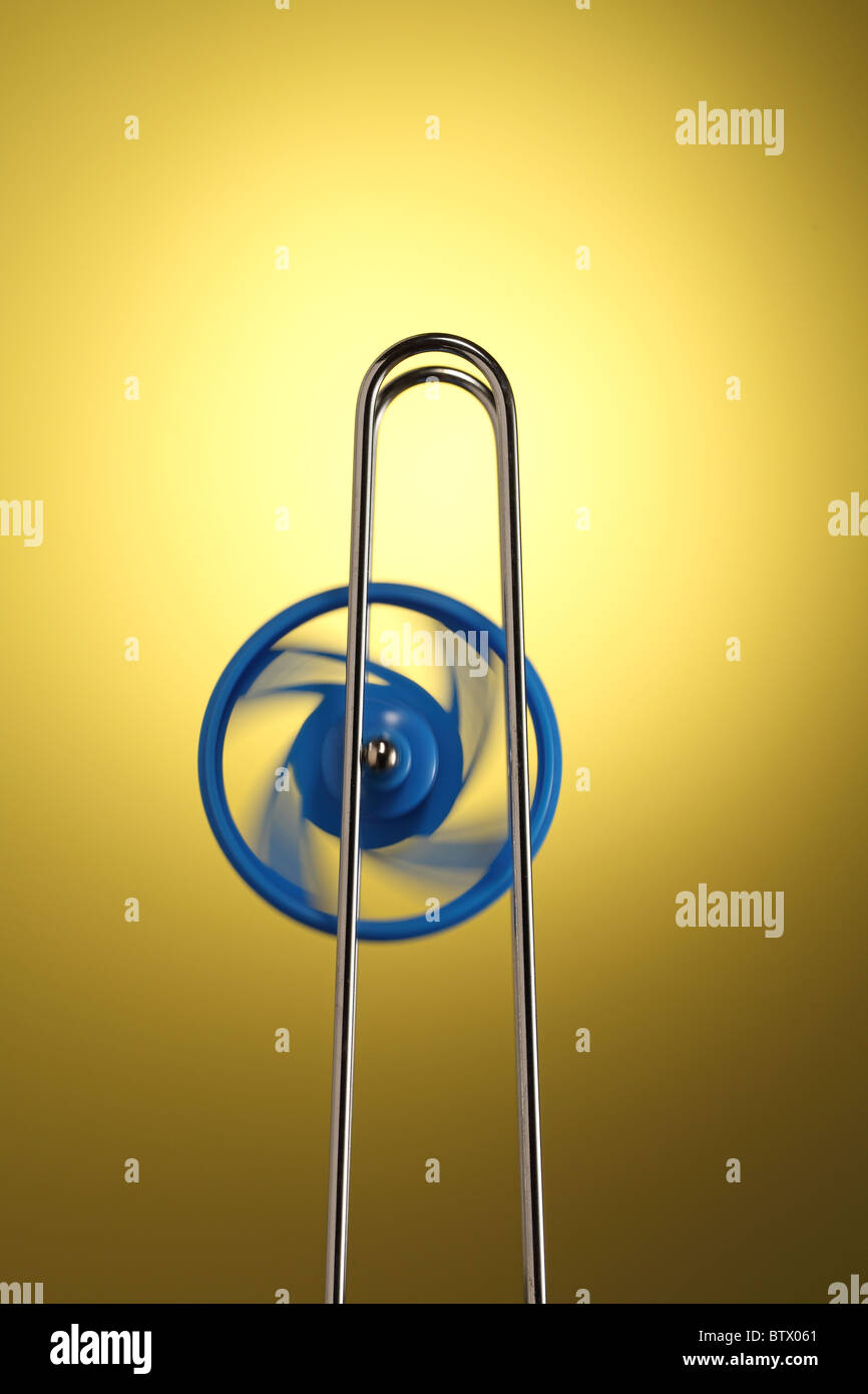 Blue wheel spinning on a silver metal rail. The wheel climbs up and ...