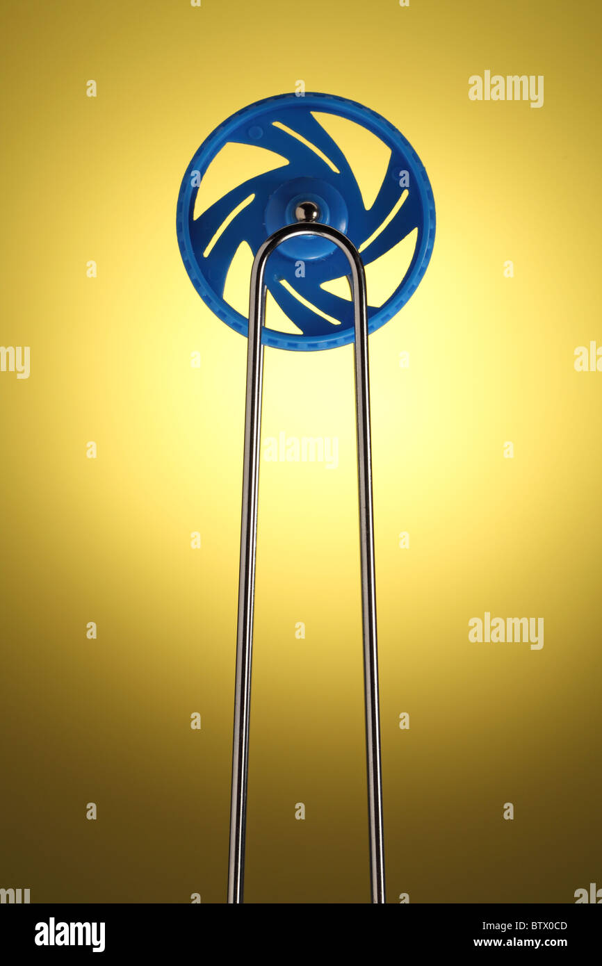 Blue wheel spinning on a silver metal rail. The wheel climbs up and ...