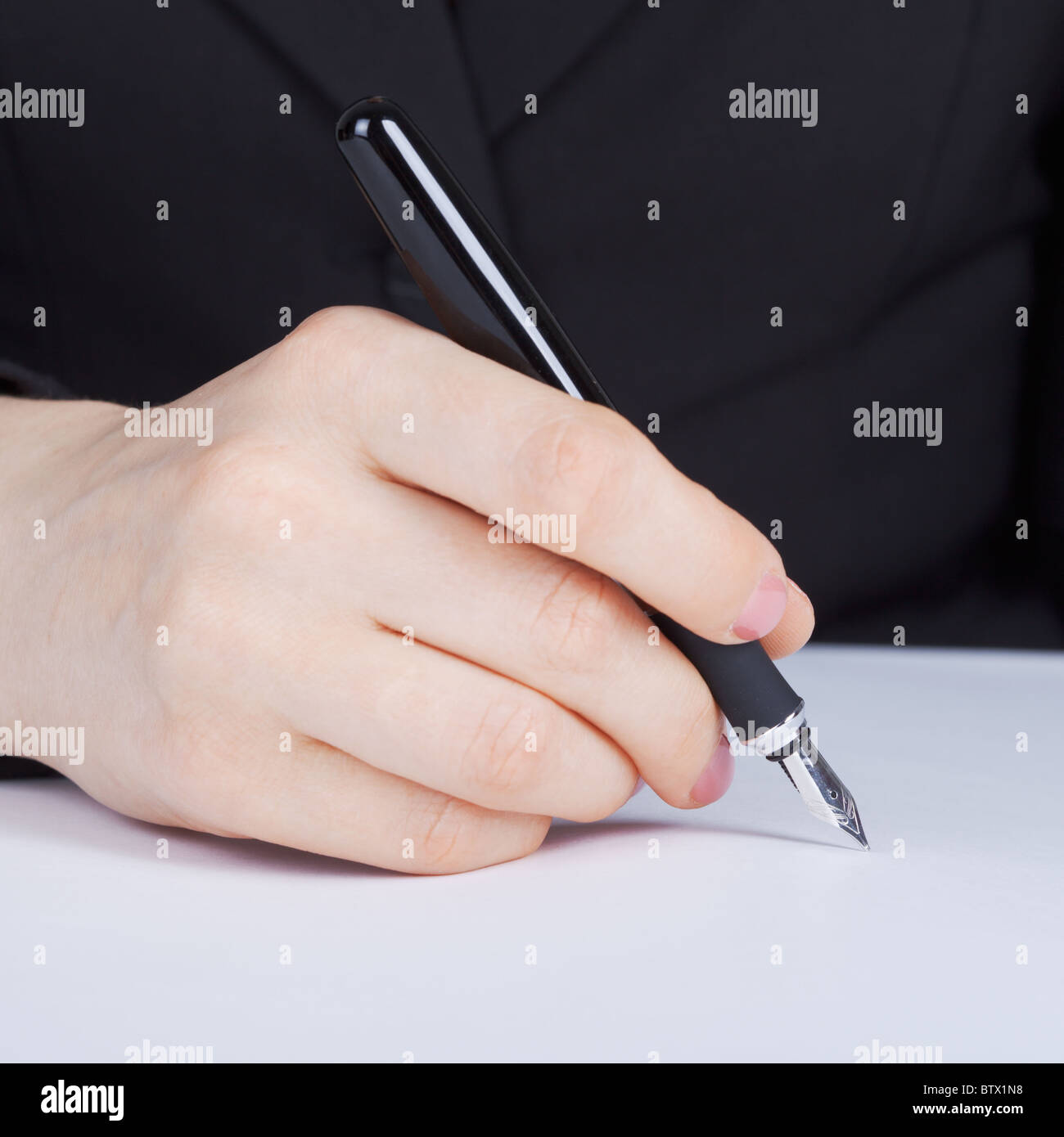 Female hand holding a fountain pen with a silver pen Stock Photo - Alamy