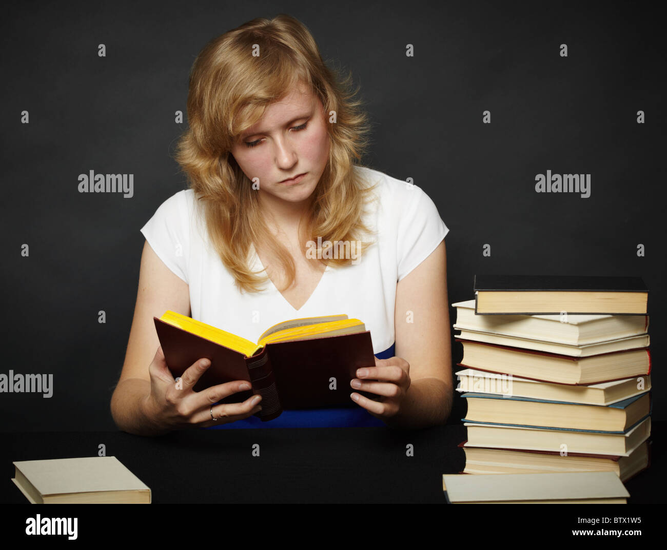 Evening reading of fiction at table in twilight Stock Photo - Alamy