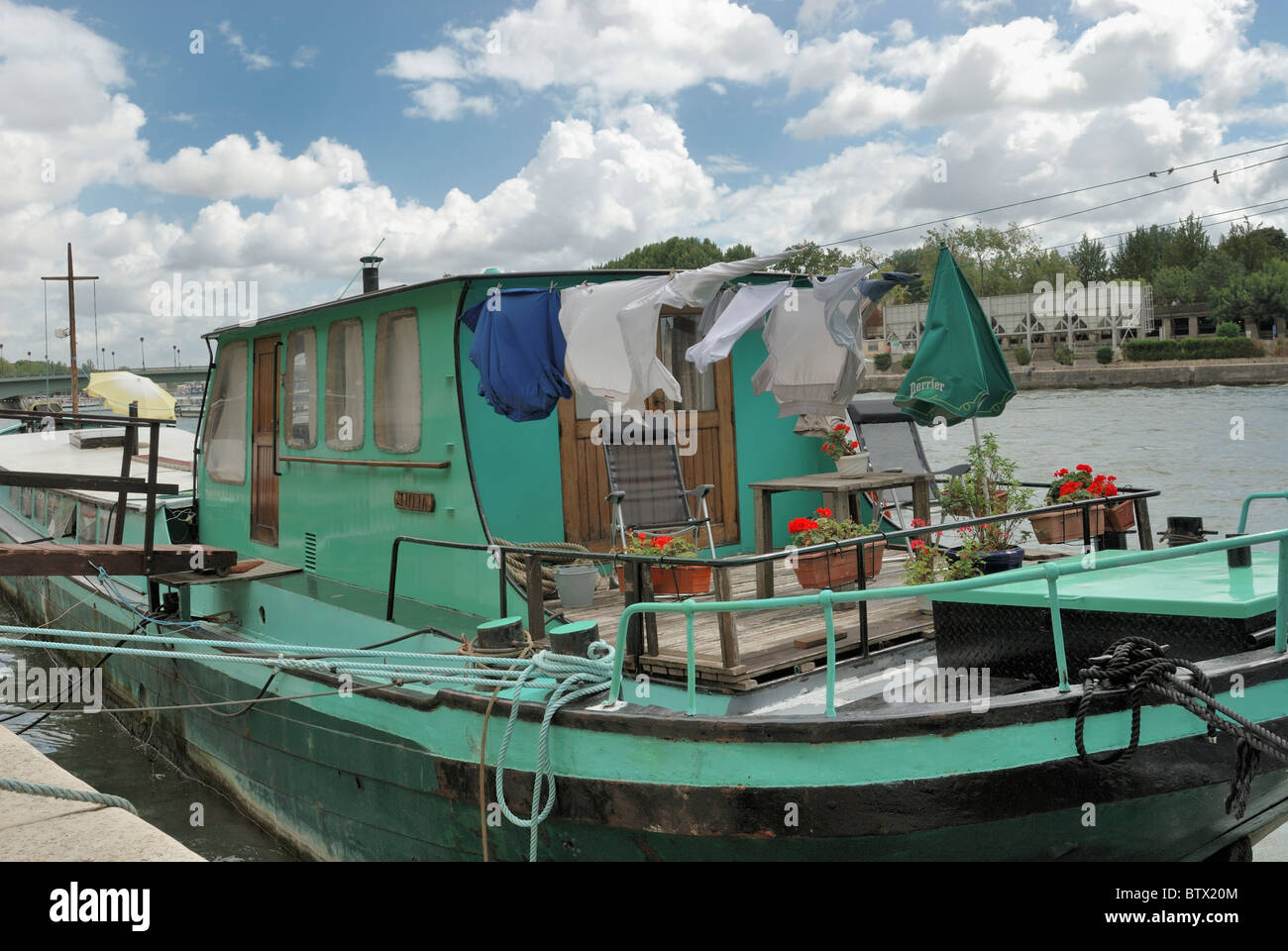 Boat on the River Seine with clothes line drying laundry on the deck ...
