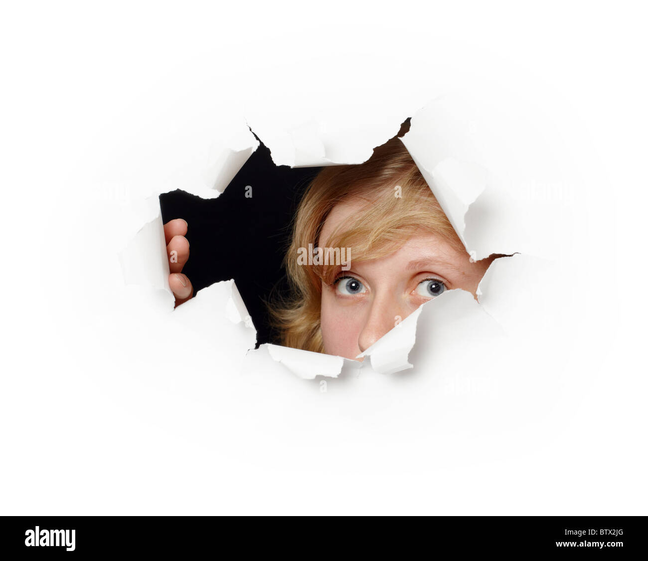A woman's face peeping out of hole - the female curiosity Stock Photo ...