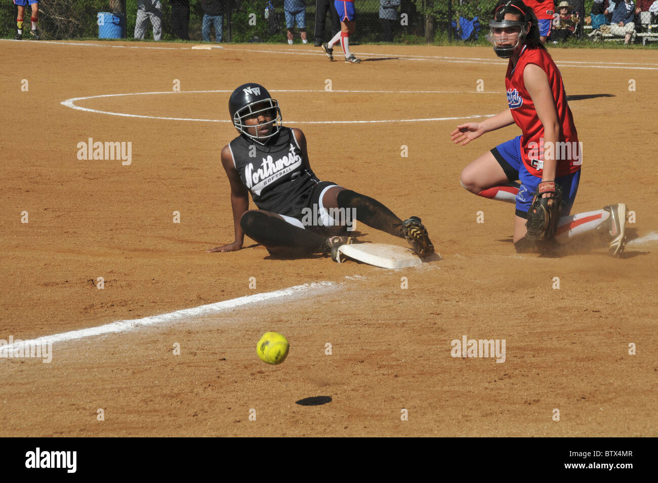 Ball gets away from 3rd baseman during a high school softball game ...