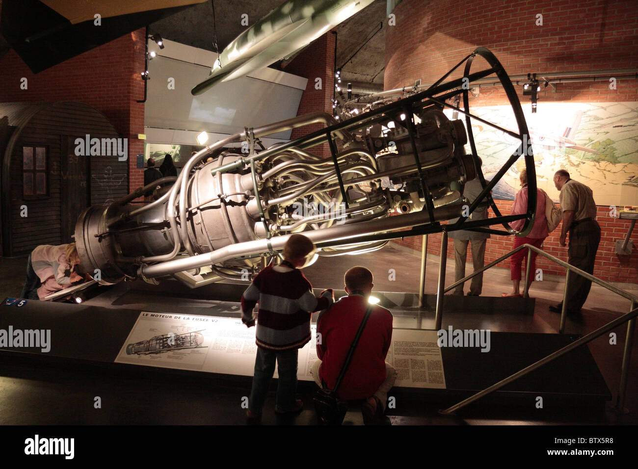 Vistitors study an engine of a V2 rocket on display at the La Coupole ...