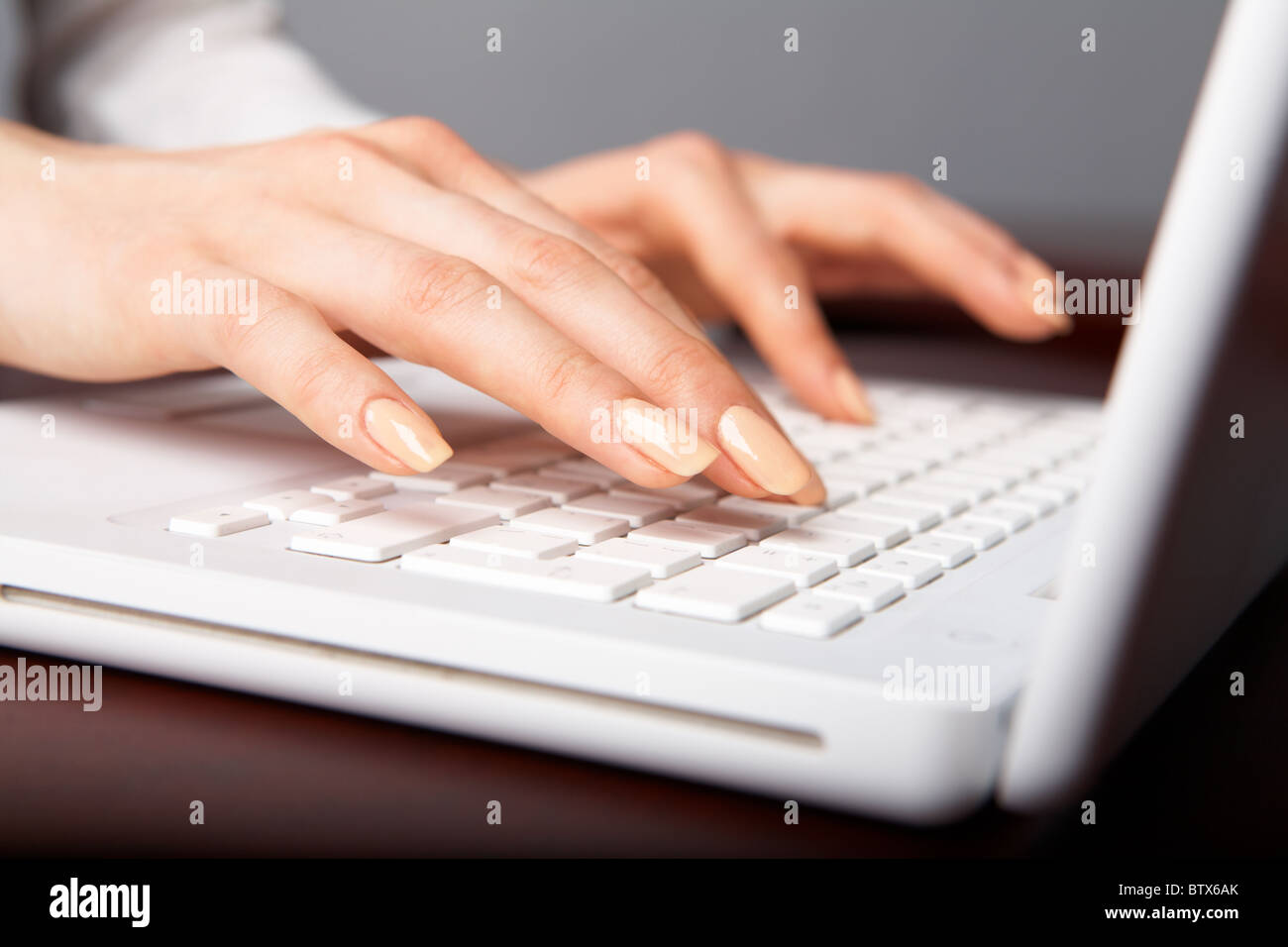 Human hands over laptop keypad during typing Stock Photo - Alamy
