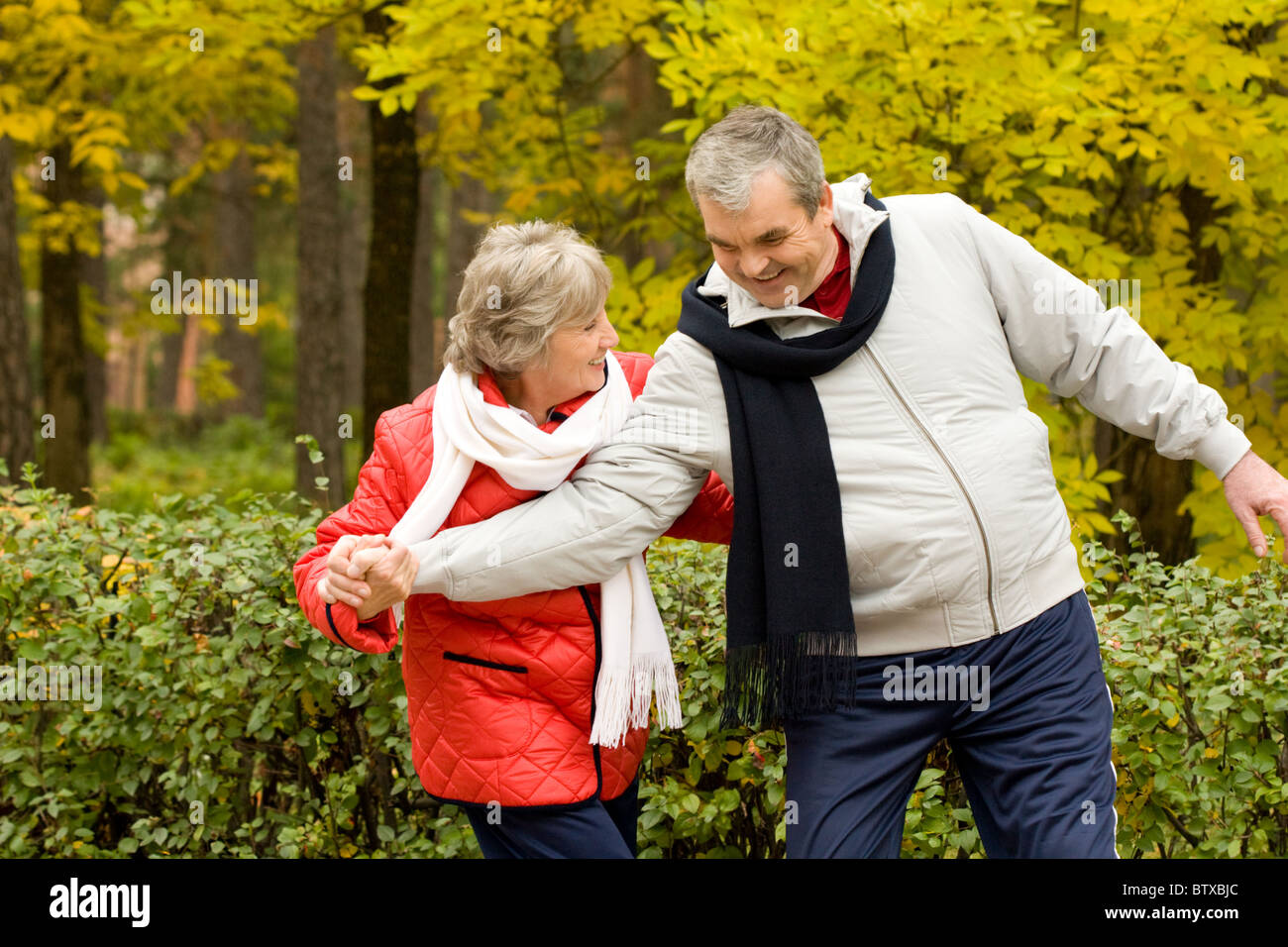 Photo of two aged people having fun during walk in autumn forest Stock ...