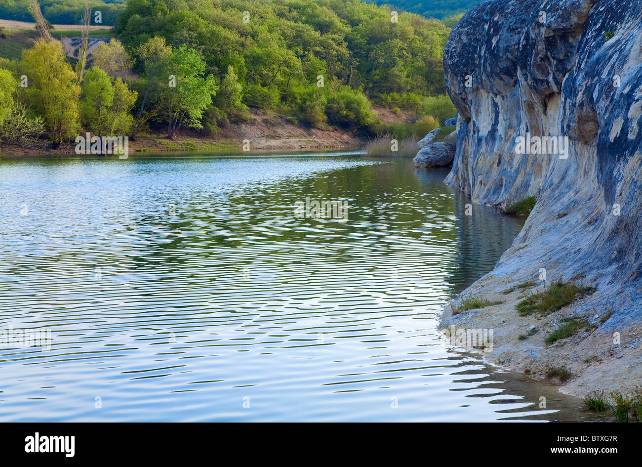 beautiful lake with spring rocky bank reflection in water surface Stock ...