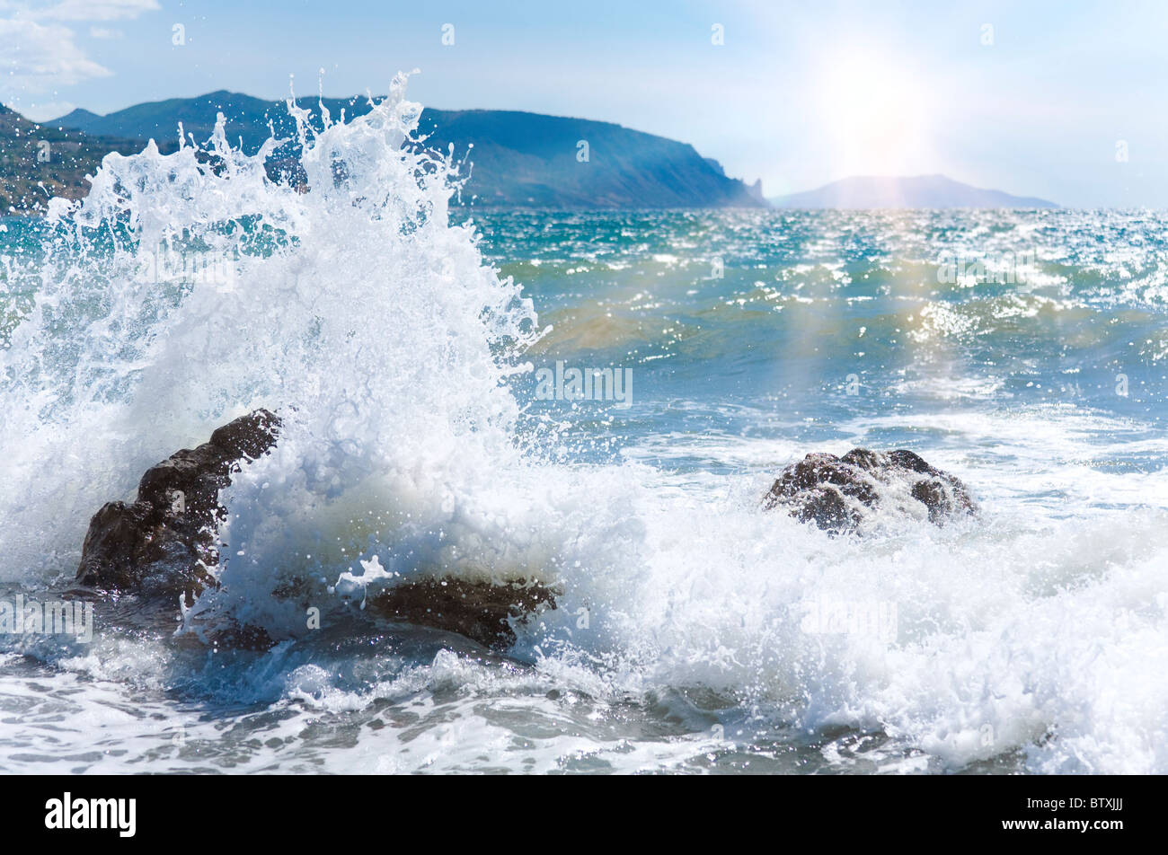 Sea surf wave break on coastline, Meganom cape on horizon right (Crimea ...